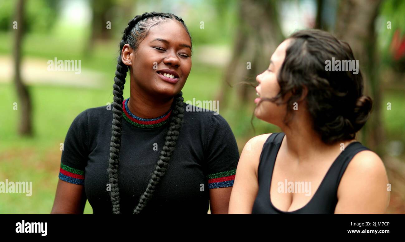 Candid female friends talking outside, real life laugh and smile Stock ...