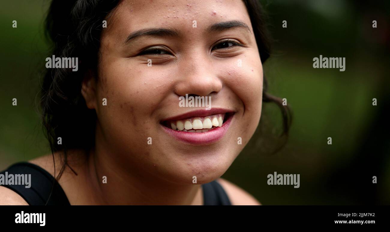 Casual Hispanic girl smiling at camera portrait. Young latina woman ...