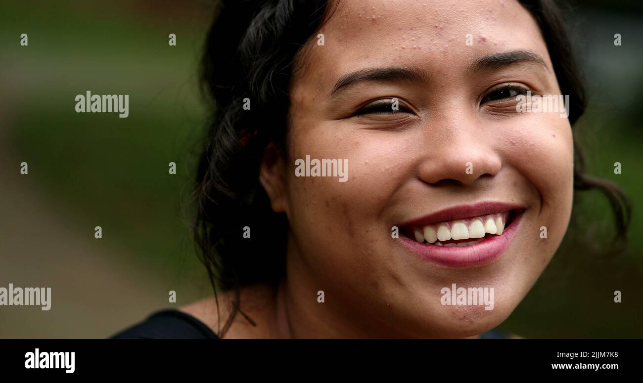 Casual Hispanic girl smiling at camera portrait. Young latina woman ...