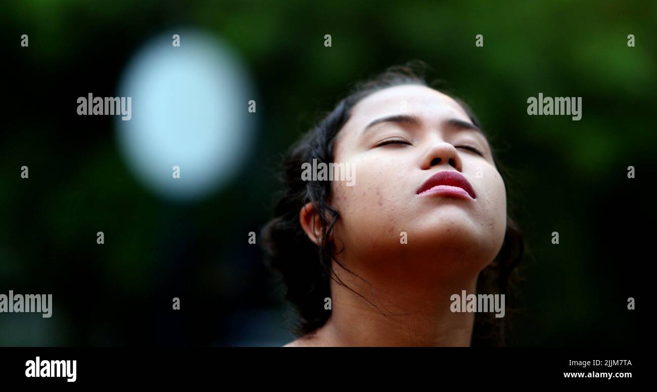 Contemplative young woman closing eyes in meditation. Close-up girl ...