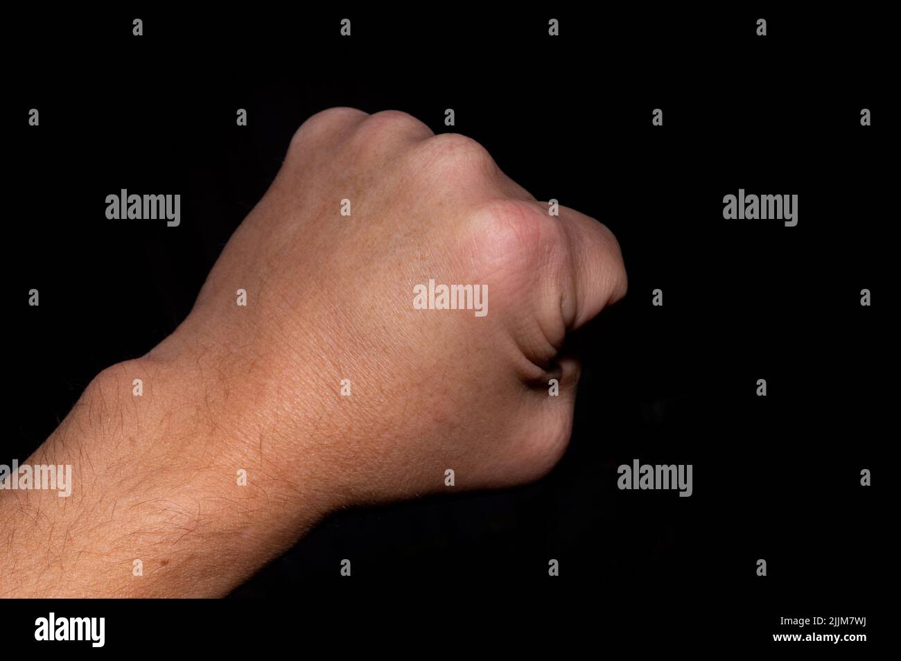 Man in black holding fist hi-res stock photography and images - Alamy