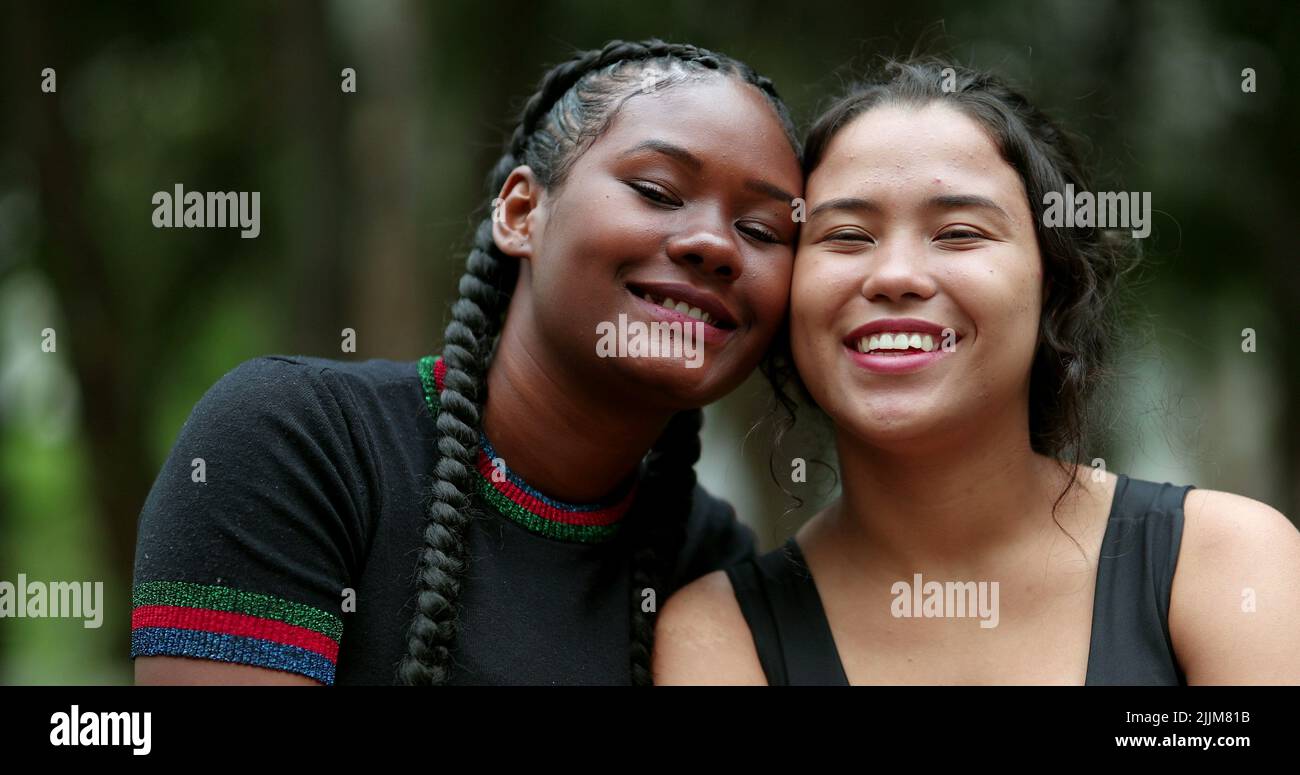 Ethnically diverse girlfriends posing together. African and hispanic ...