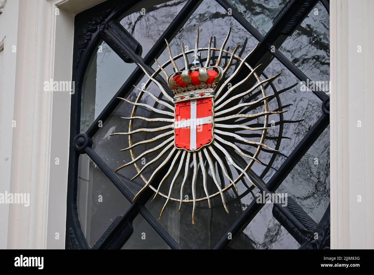 The swiss red and white metallic coat of arms on a glass door Stock ...