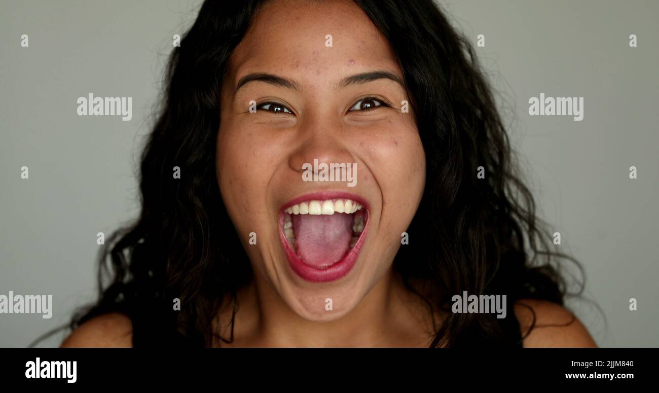 Excited happy hispanic girl cheering success reaction to great news ...