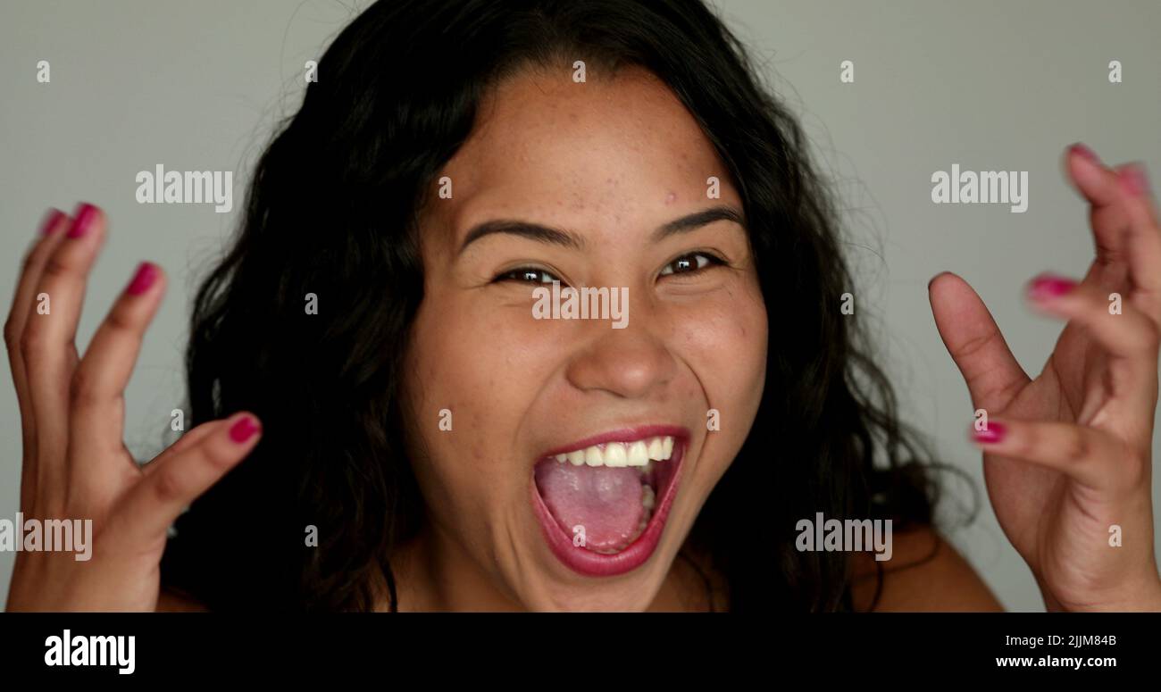 Excited happy hispanic girl cheering success reaction to great news ...