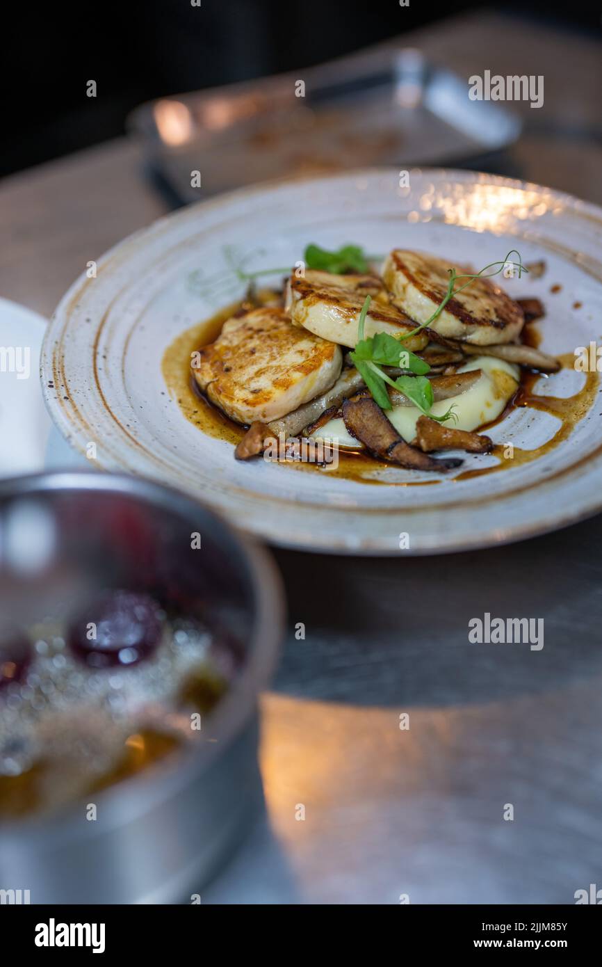 A shallow focus of Chicken Ballotine, smoked potato mash, sauteed ...