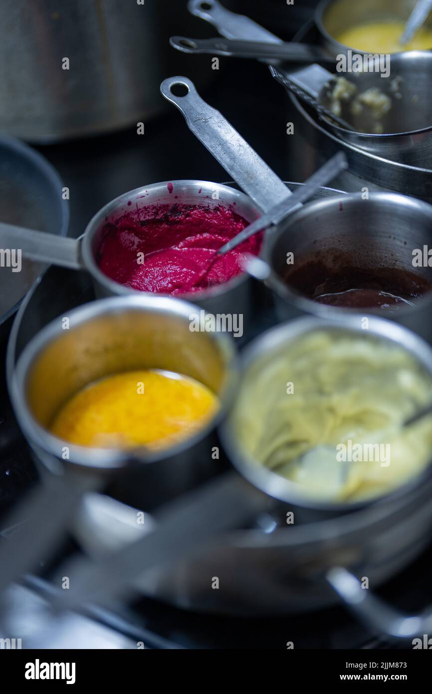 A closeup of Steel pots with a variety of French Fine Dining Condiments ...