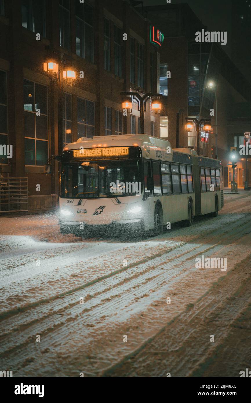 A bus in snowy street at night Stock Photo - Alamy