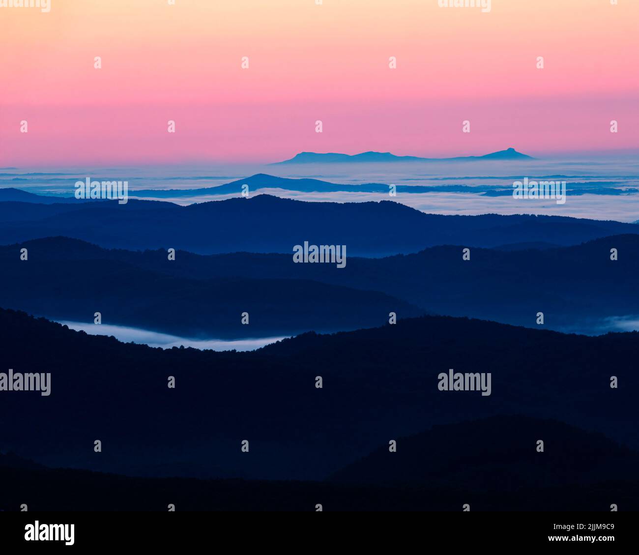 Mountains rise above the clouds in predawn light as seen from the Blue ...