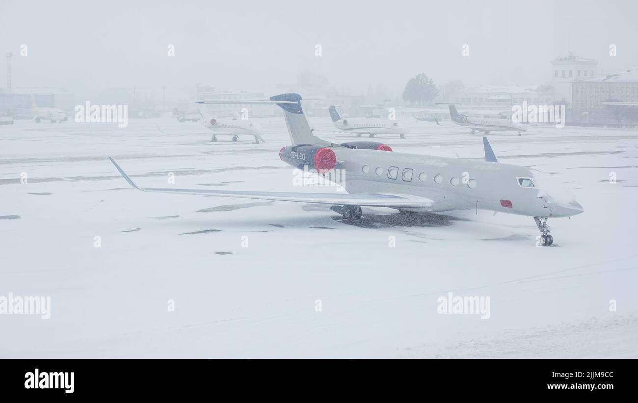 Snow covered commercial plane at the airport. Close-up of the plane ...
