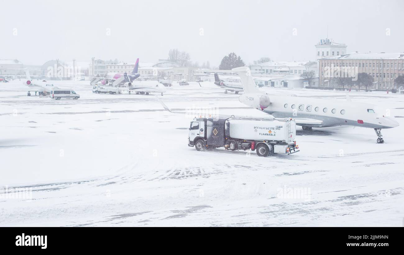 Snow covered commercial plane at the airport. Close-up of the plane ...
