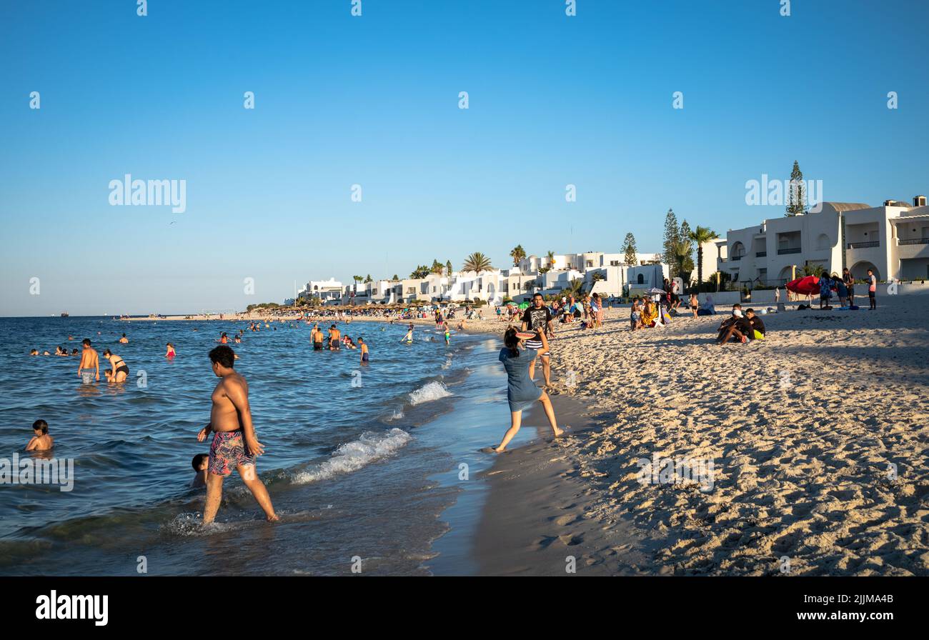 People enjoy the beach in late afternoon at Port El Kantaoui, Tunisia ...
