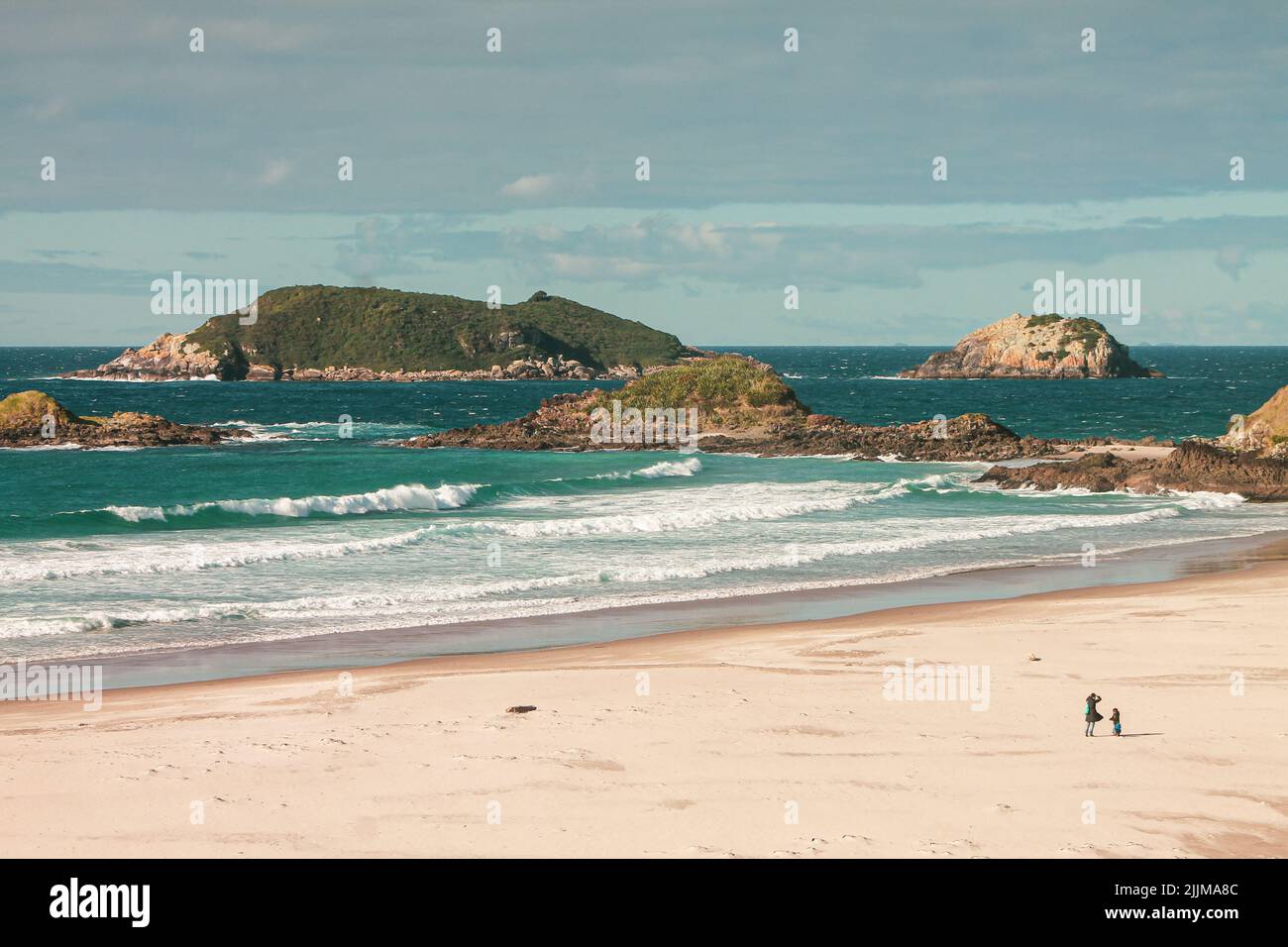 A beautiful view of a beach with a wavy ocean Stock Photo - Alamy