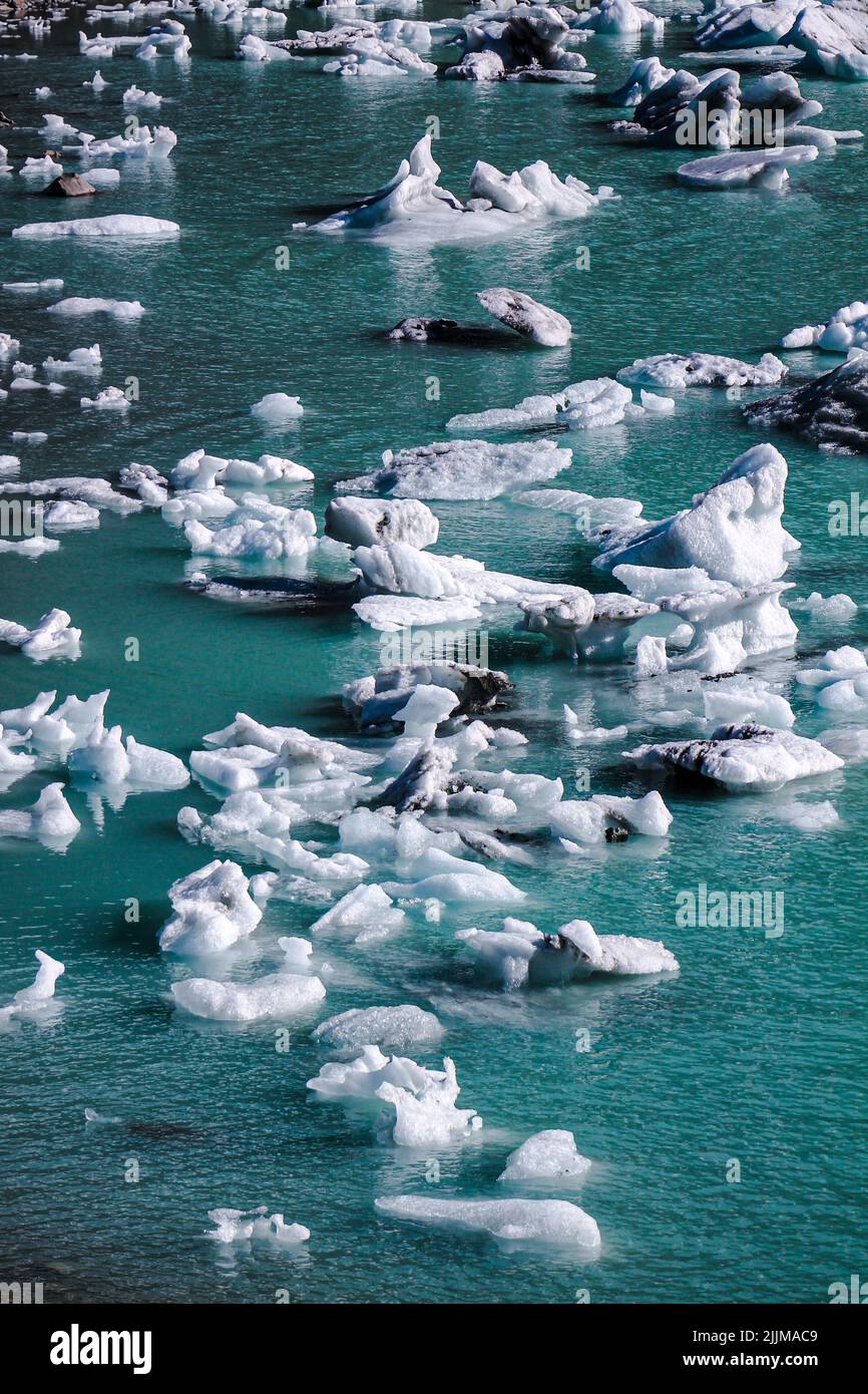A vertical shot of floating glaciers in the ocean Stock Photo - Alamy
