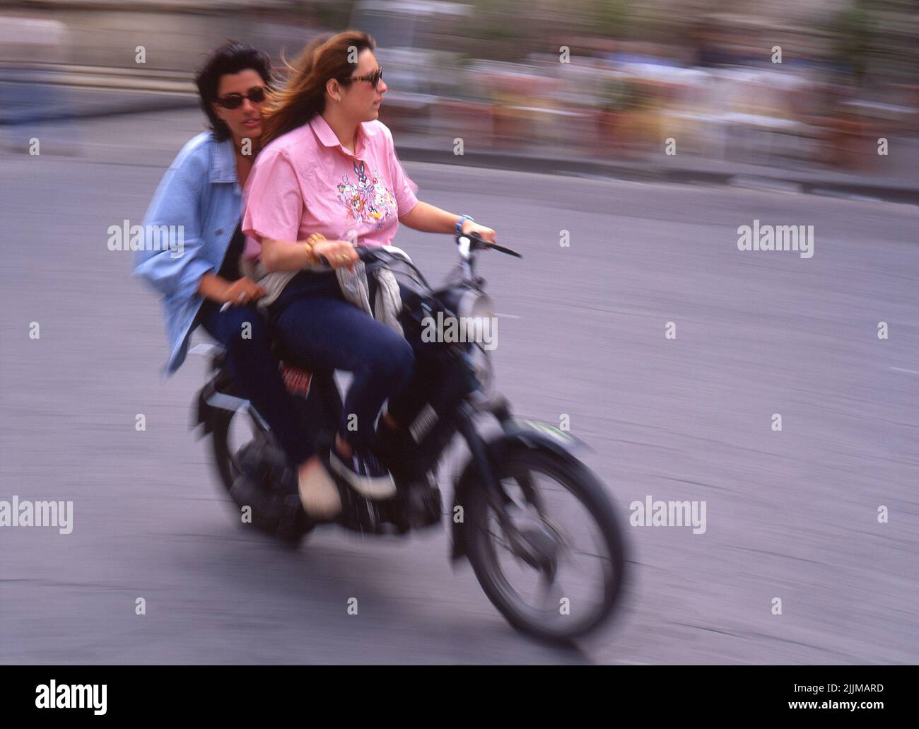 Urban motorcycle with two female riders, Syracuse, Sicily Stock Photo ...