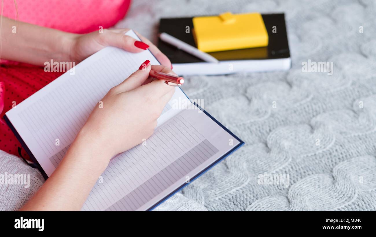 Woman writing diary bed hi-res stock photography and images - Alamy
