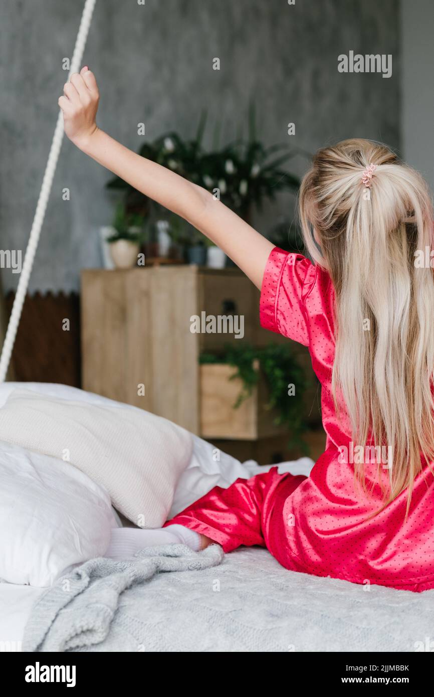 morning coziness blonde woman bed arms stretched Stock Photo - Alamy