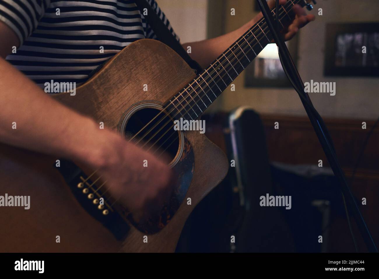 A man playing classic guitar in a concert Stock Photo - Alamy