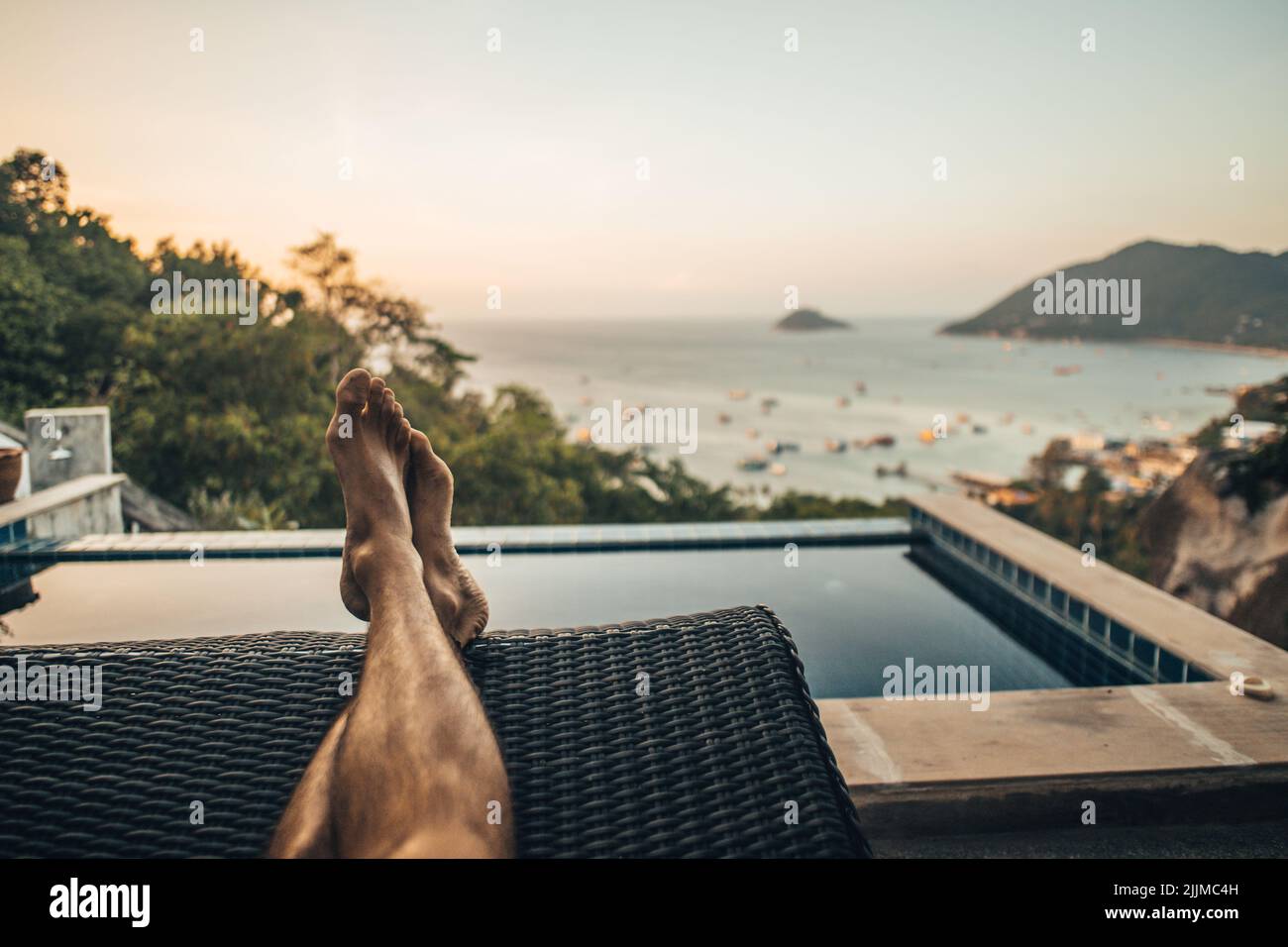 A man Chilling at home with a sunset and sea view in Thailand Stock ...