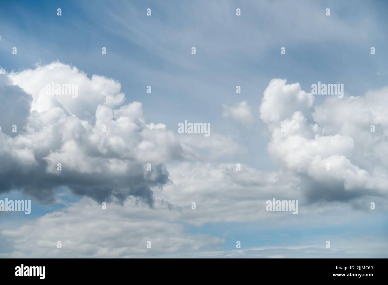 Blue sky with white light clouds in the foreground Stock Photo - Alamy