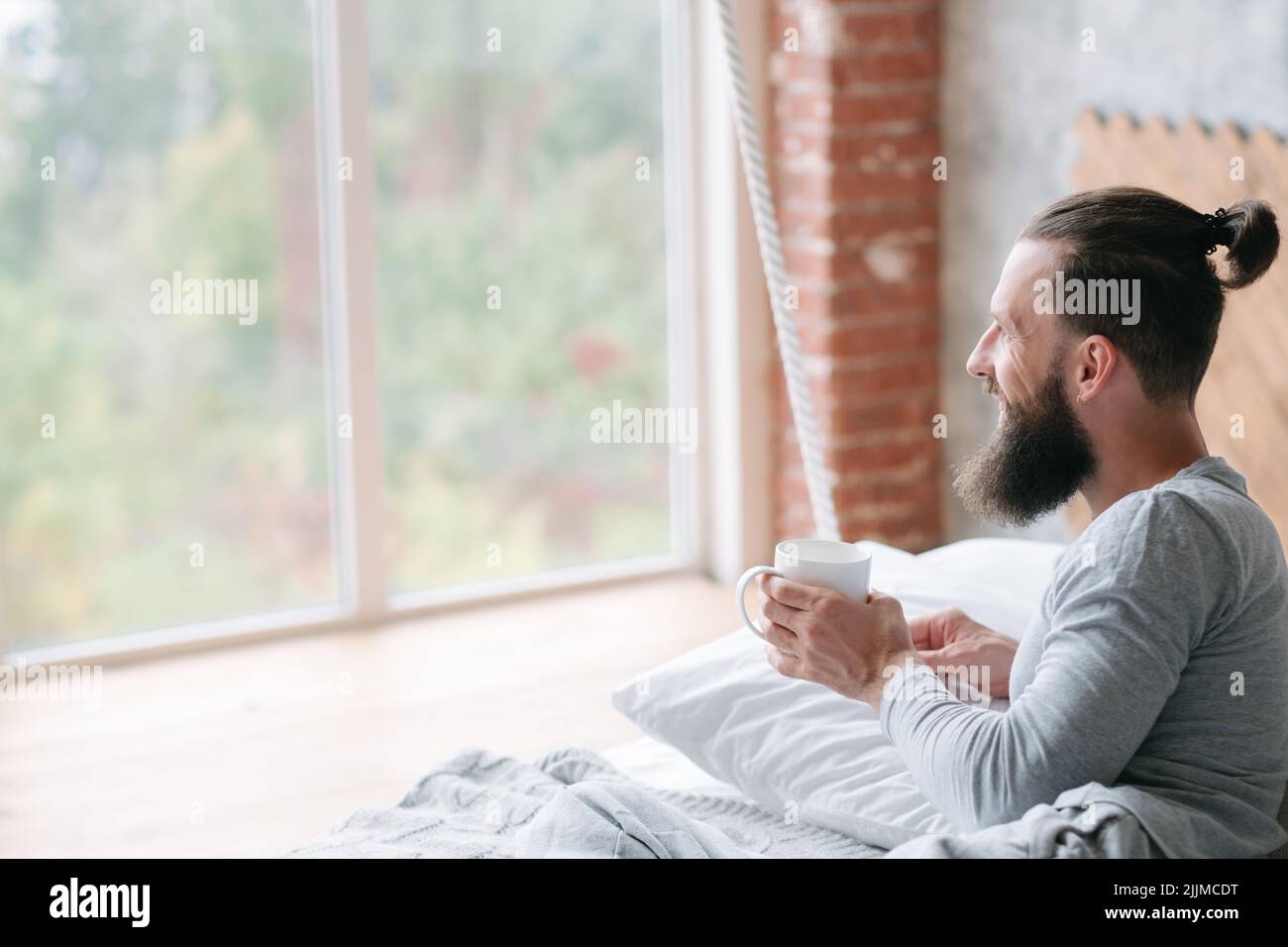 man coffee lyingbed looking window morning leisure Stock Photo - Alamy