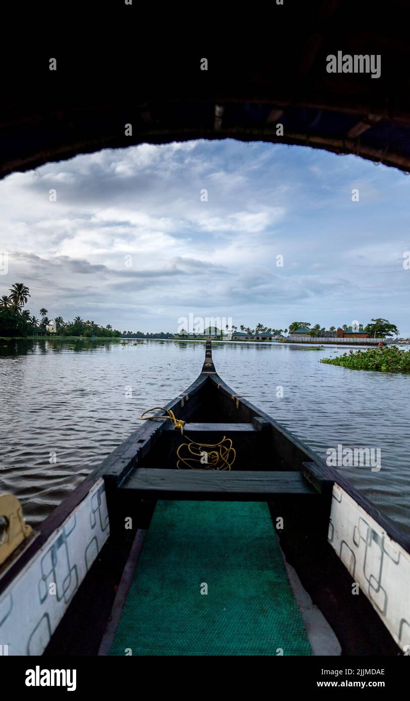An old wooden boat crossing under a bridge Stock Photo - Alamy