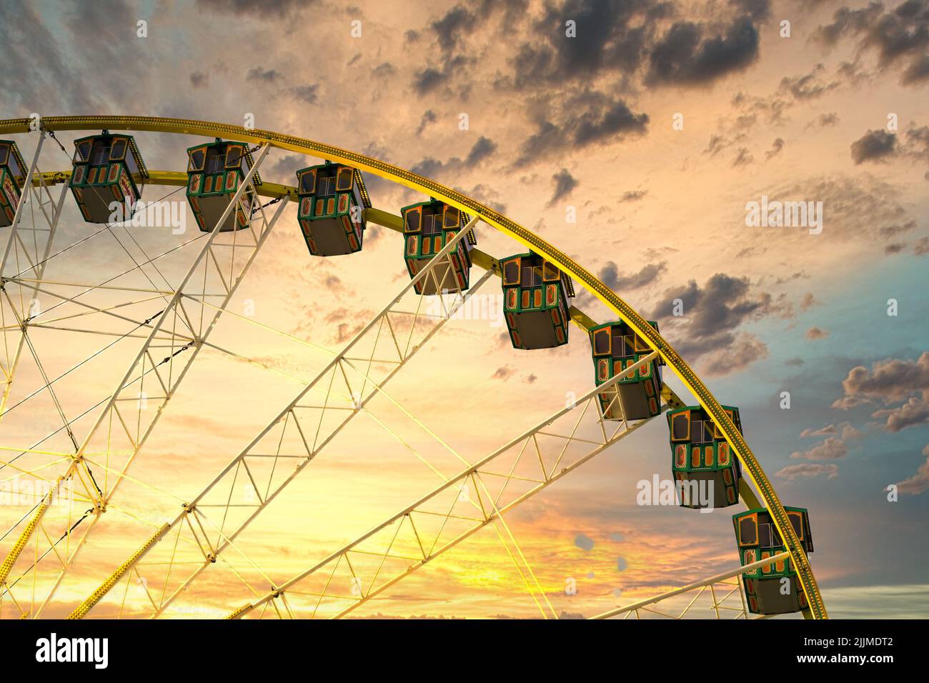 A low angle shot of an illuminated ferris wheel in an amusement park at ...