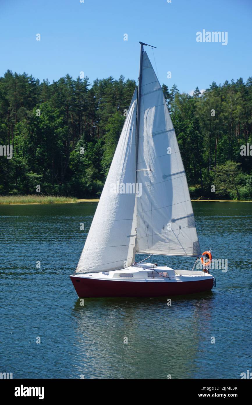 Sailboat swimming on a lake - side view Stock Photo - Alamy