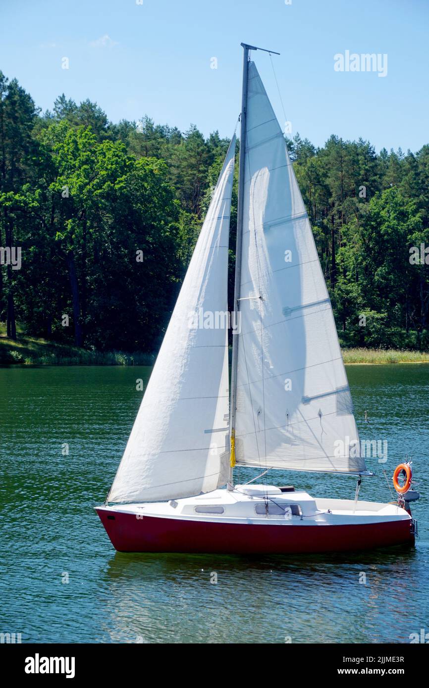 Sailboat swimming on a lake - side view Stock Photo - Alamy