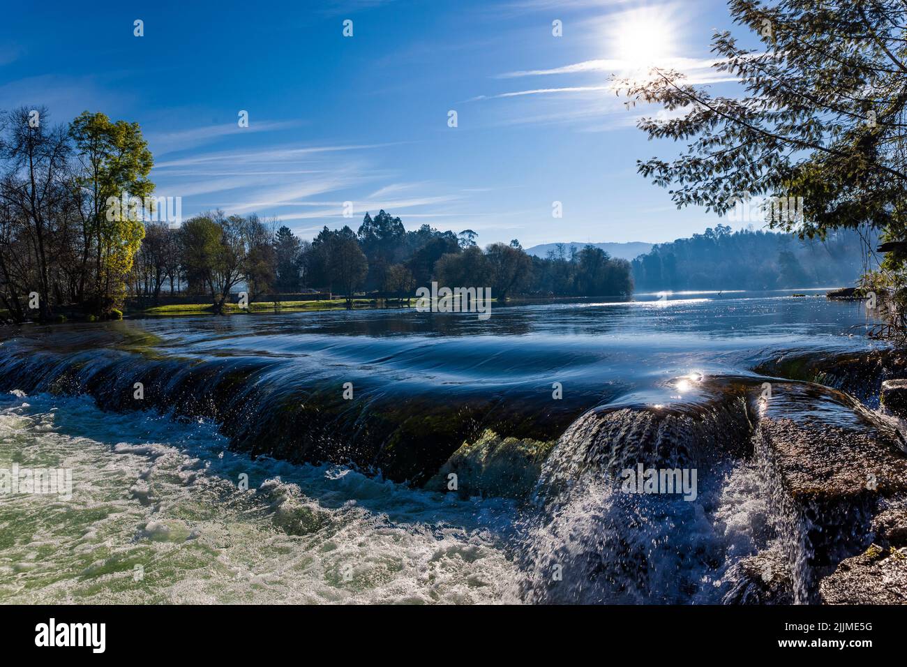 A beautiful shot of a river surrounded by trees on a sunny day Stock ...