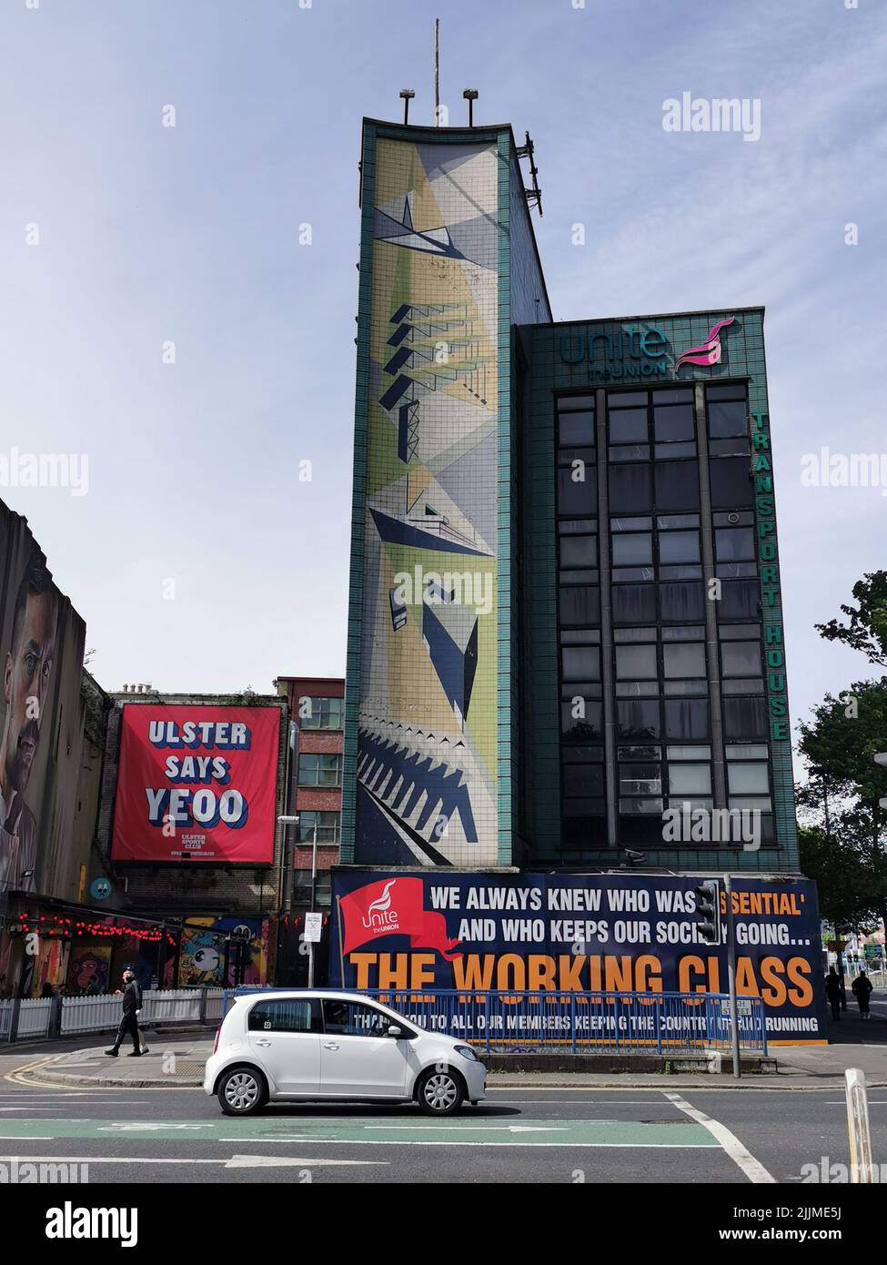 A vertical shot of a Unite Union building in Belfast with artwork on it ...