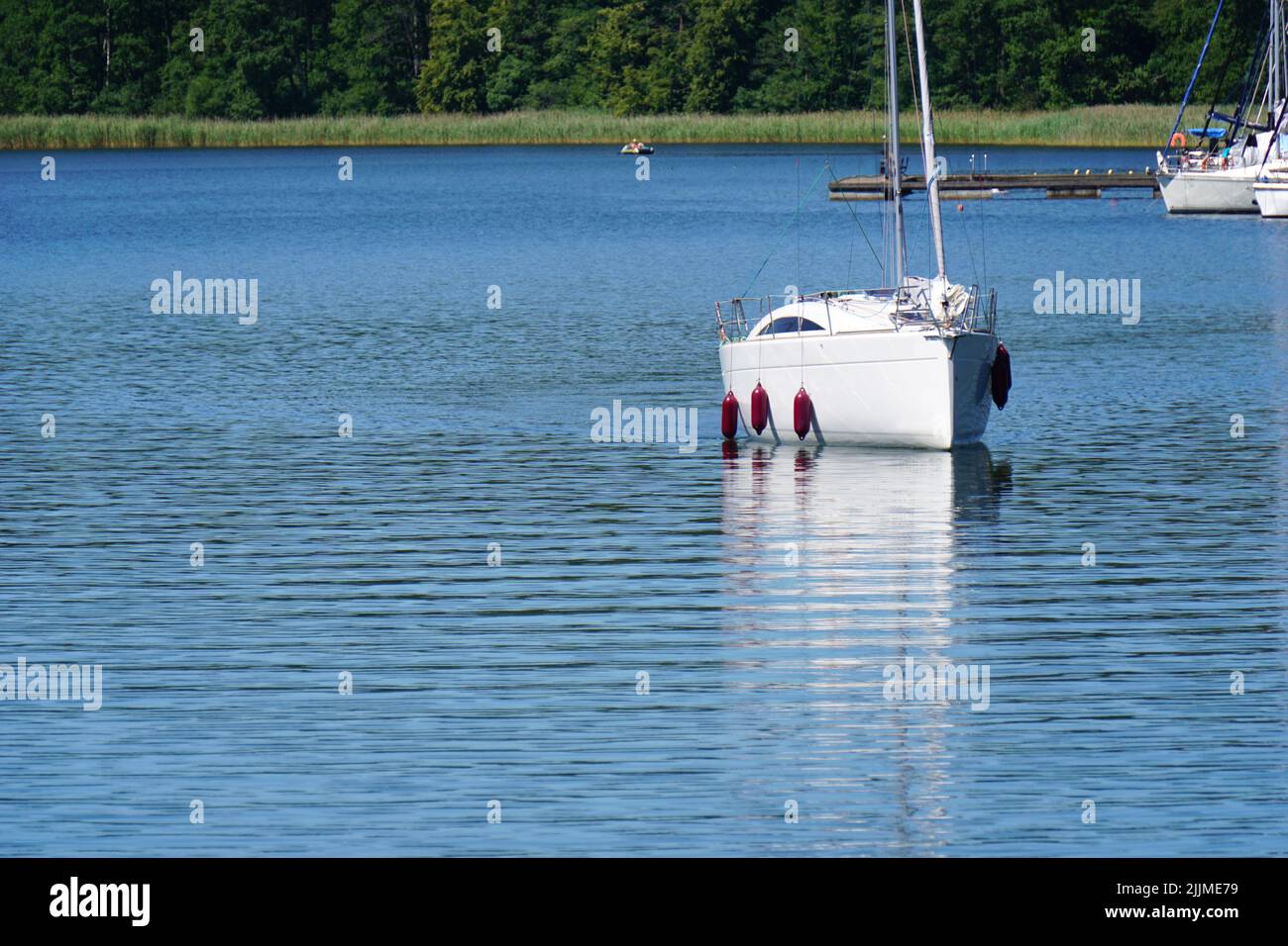 Sailboat swimming with en engine - front view Stock Photo - Alamy