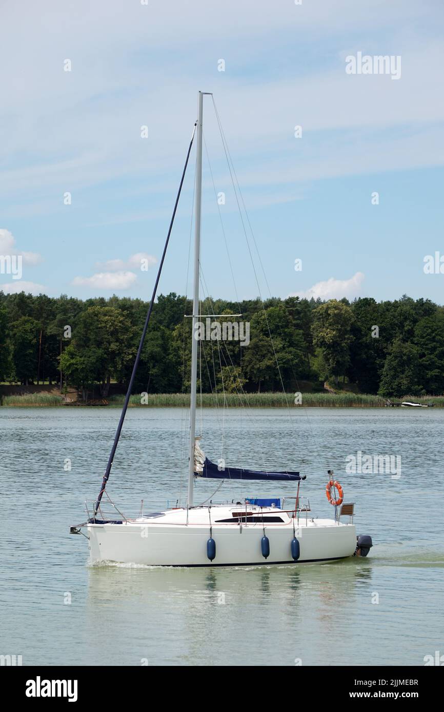 Sailboat swimming with en engine - side view Stock Photo - Alamy
