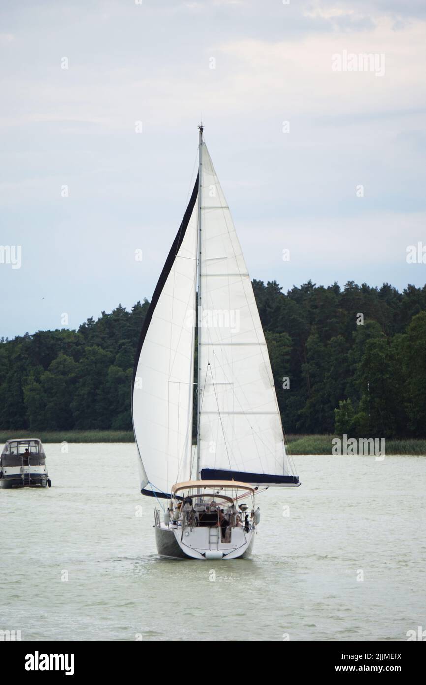 Sailboat swimming on a lake - back view Stock Photo - Alamy