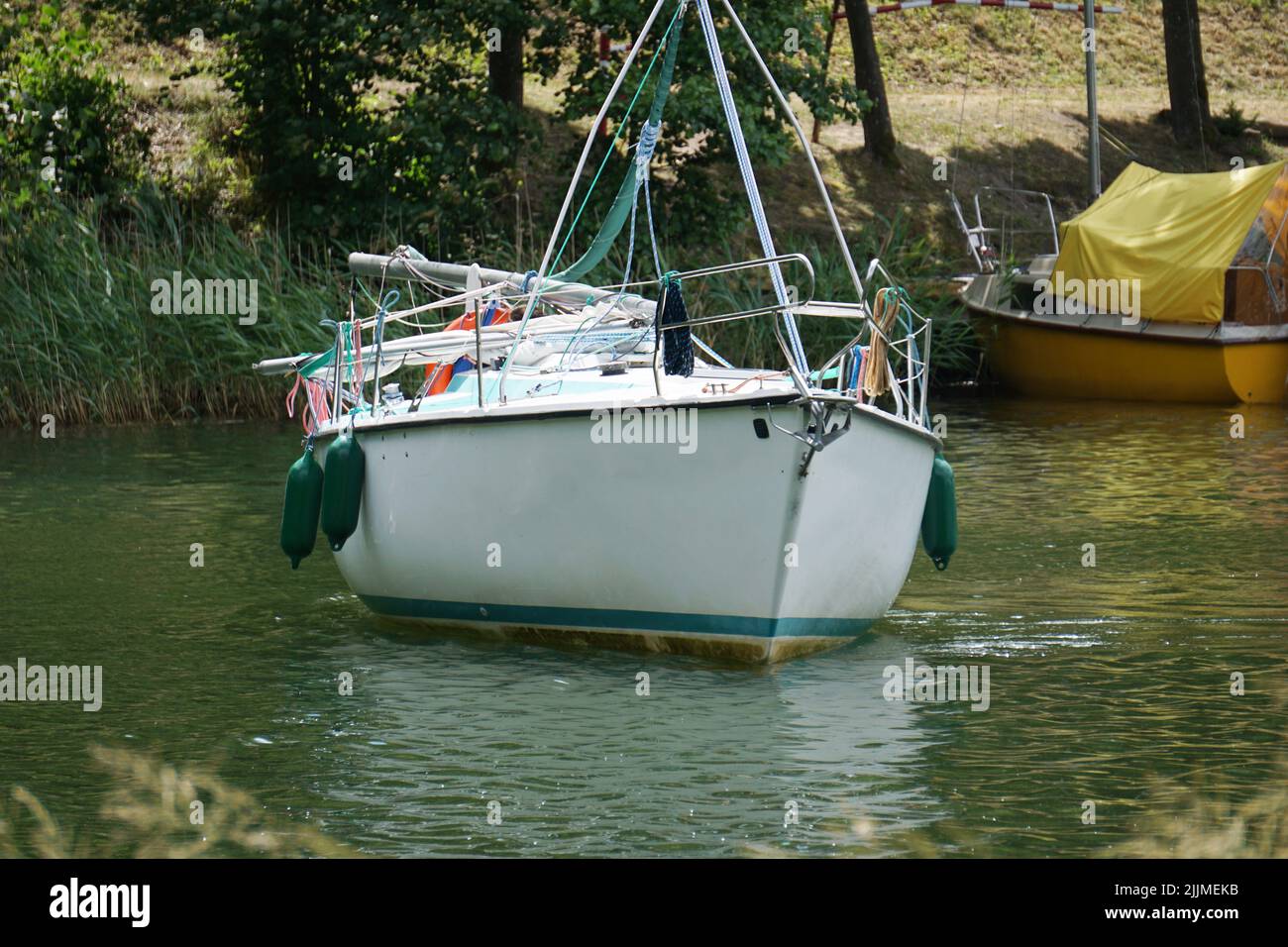 Sailboat swimming with en engine - front view Stock Photo - Alamy