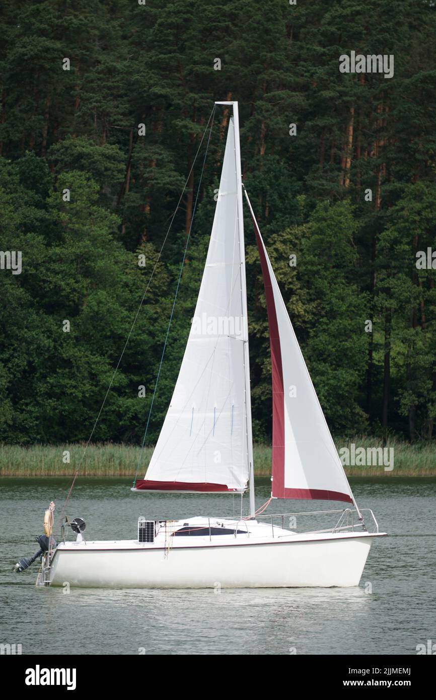 Sailboat swimming on a lake - side view Stock Photo - Alamy