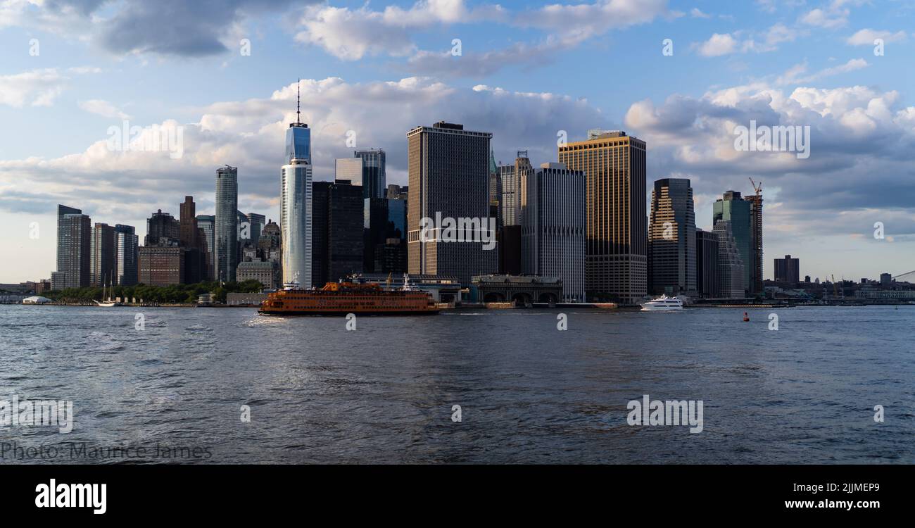 A view of ferry standing in front of Governor island buildings in ...