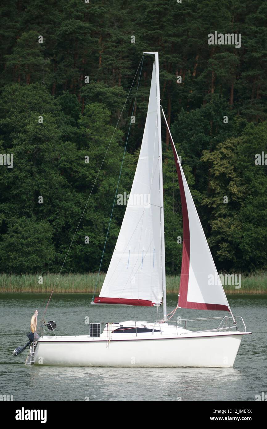 Sailboat swimming on a lake - side view Stock Photo - Alamy