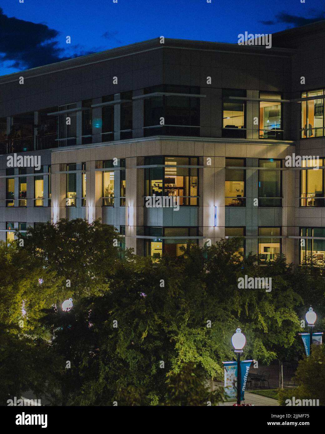 The exterior of an illuminated office building at night Stock Photo - Alamy