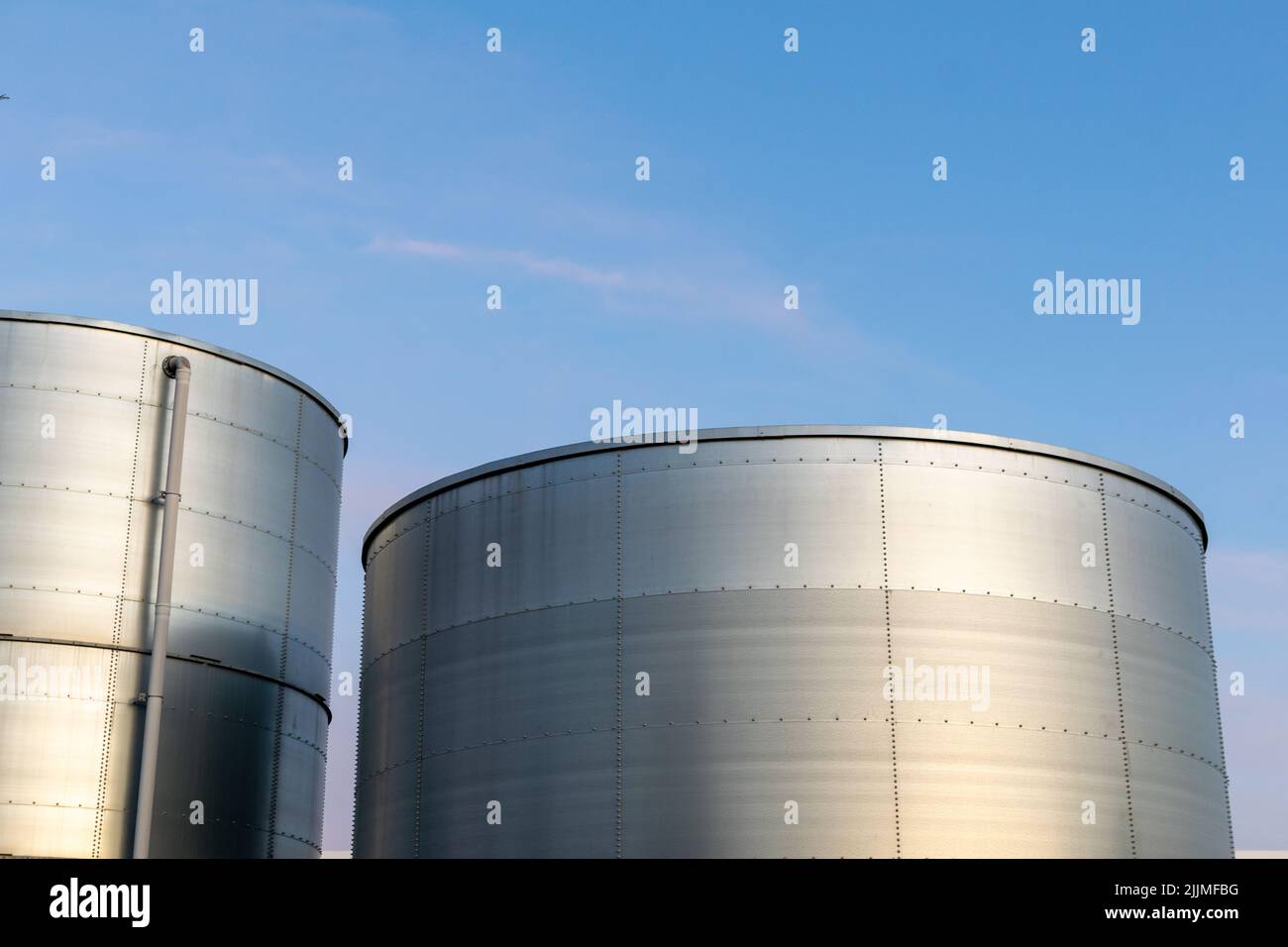 An outside large metal tanks on a clear blue sky background Stock Photo ...