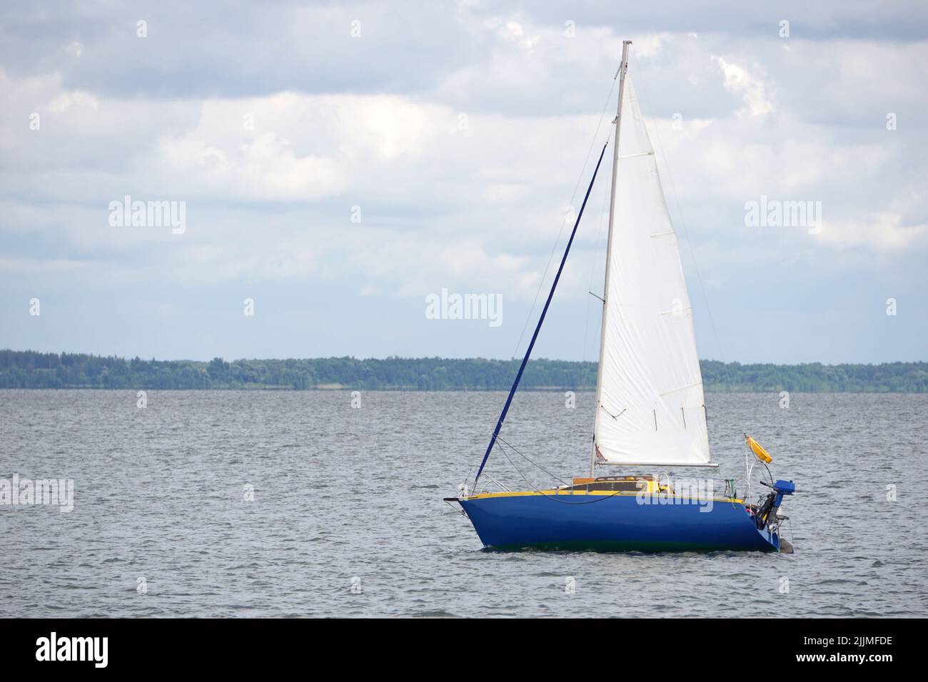 Sailboat swimming on a lake - side view Stock Photo - Alamy