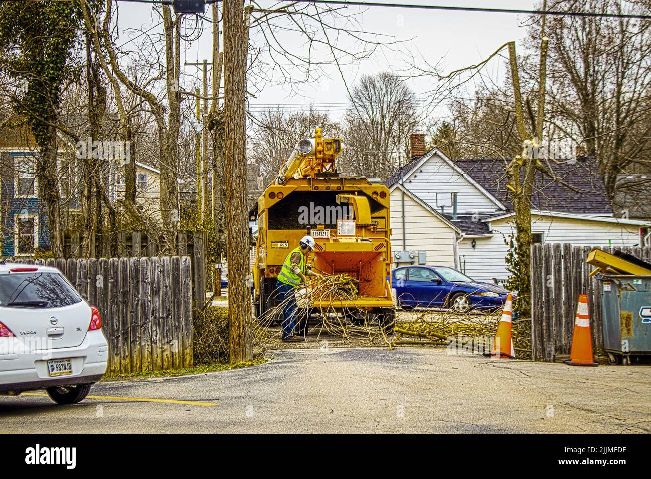 2021 03 24 Bloomington IN USA - City worker shoves cut tree branches ...