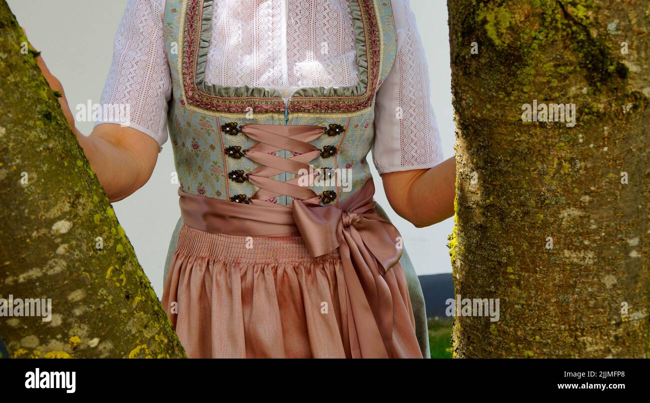 a woman in a beautiful traditional Bavarian dirndl dress at the ...