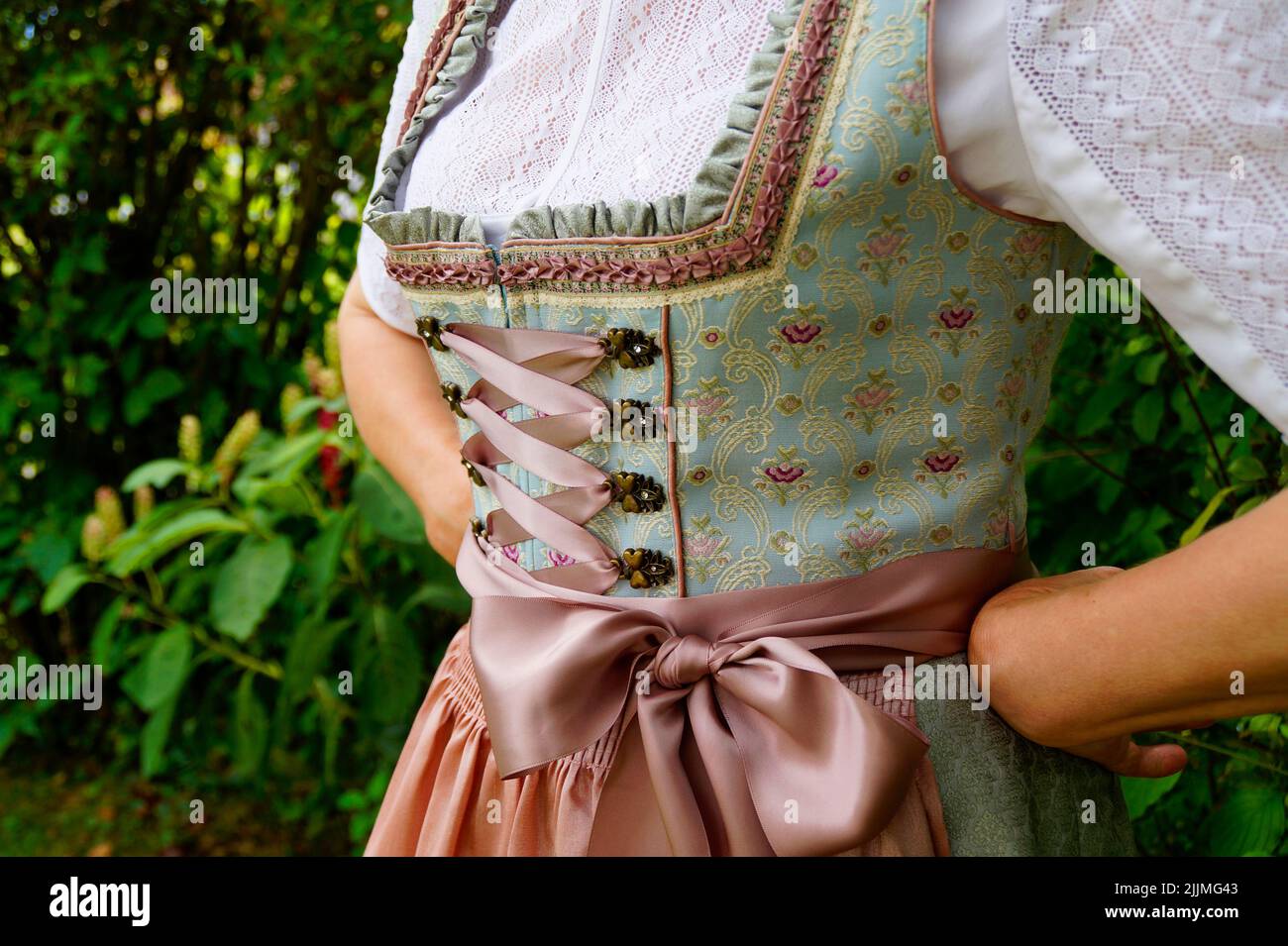 a woman in a beautiful traditional Bavarian dirndl dress at the ...