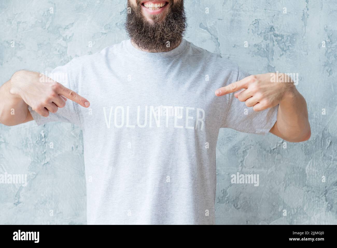 volunteering modern lifestyle man volunteer sign Stock Photo - Alamy