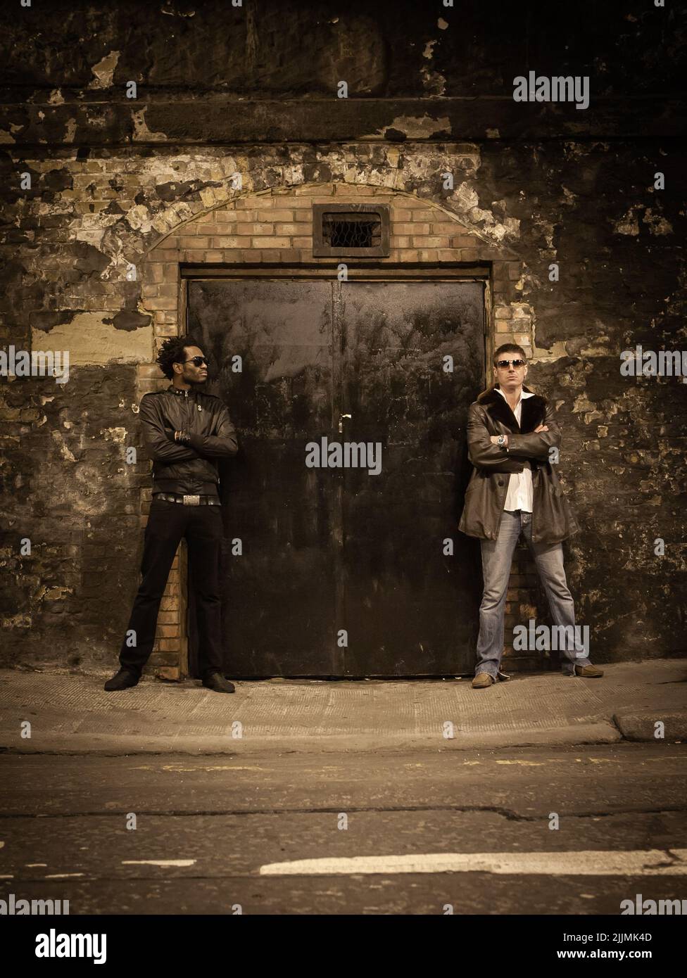 Door Security. A pair of nightclub security staff standing guard by an ...