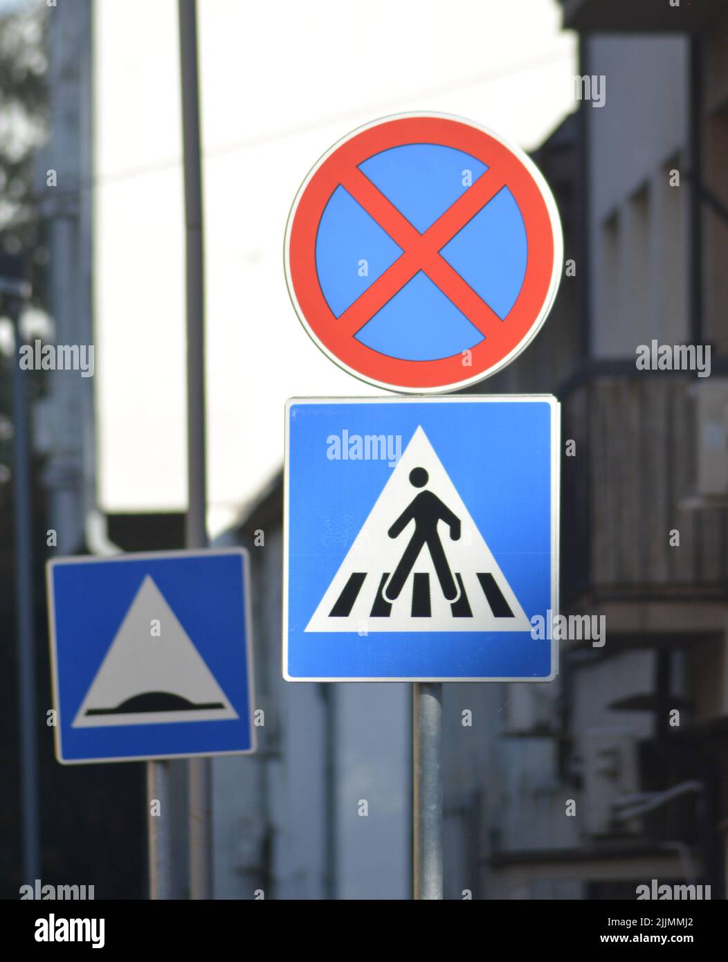 tree traffic signs on metal poles in the street Stock Photo - Alamy