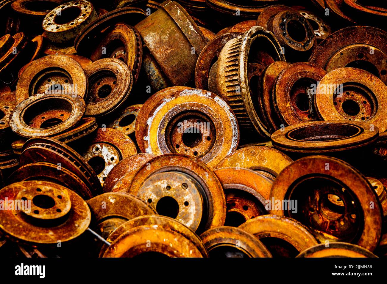A close-up shot of a bunch of scrap brake discs stored for recycling ...