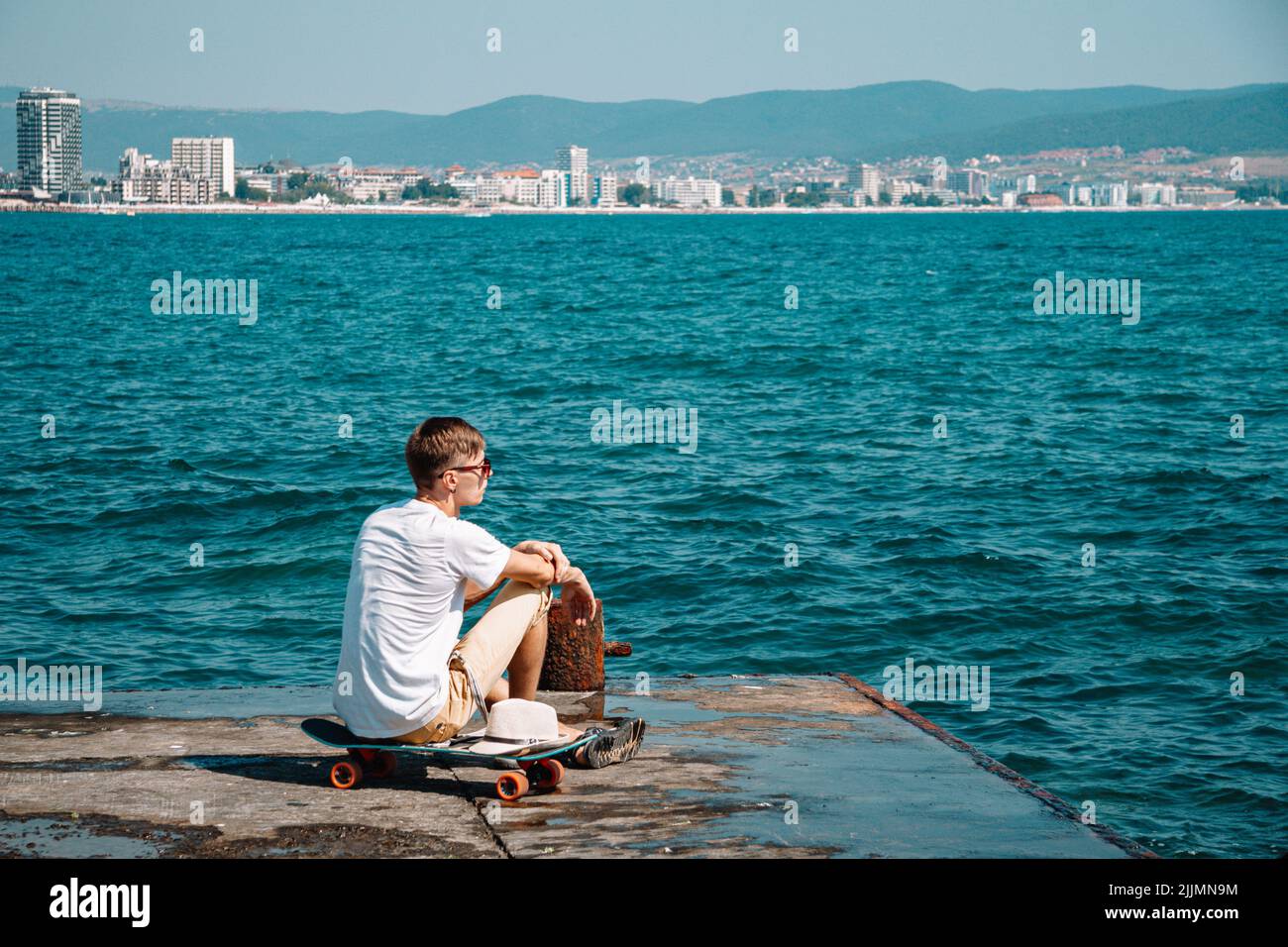 Man sitting on dock hi-res stock photography and images - Alamy
