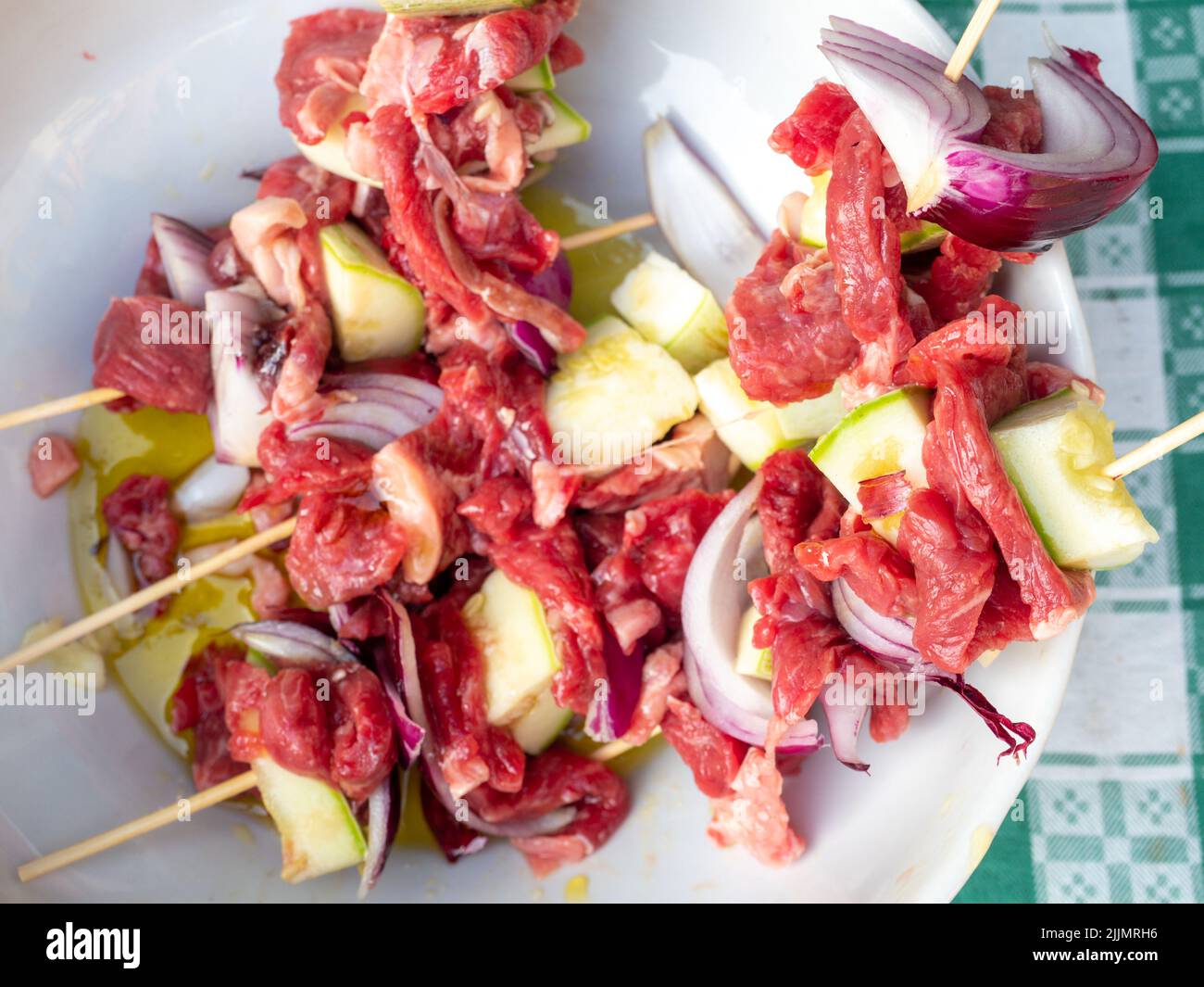 preparing pastured meat and organic vegetables skewers Stock Photo - Alamy